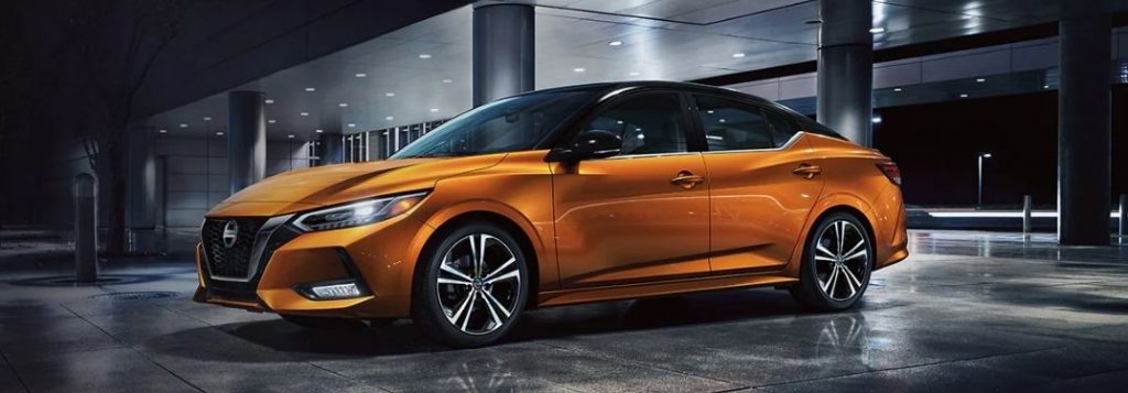 2022 Nissan Sentra in Monarch Orange Metallic at night parked in front ...