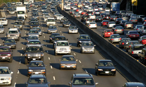 an overhead view of a huge traffic jam on a highway packed with vehicles